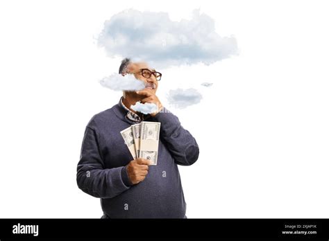 Happy Mature Man Holding Money And Thinking With Clouds Around His Head