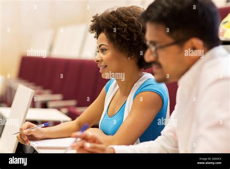 Group Of Students With Notebooks In Lecture Hall Stock Photo Alamy