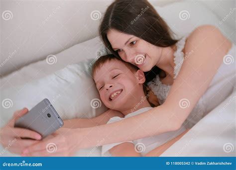 Mom And Son Take Selfie On Her Mobile Phone Morning In Bed Stock Photo Image Of Love Funny