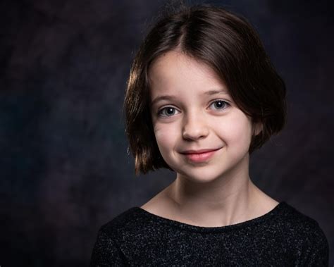 Premium Photo Portrait Of Smiling Girl Against Wall