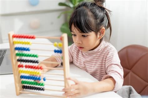 Premium Photo A Young Cute Asian Girl Is Using The Abacus With