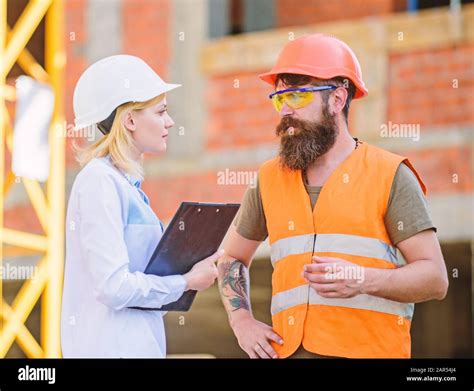 Woman Engineer And Bearded Brutal Builder Discuss Construction Progress Construction Project