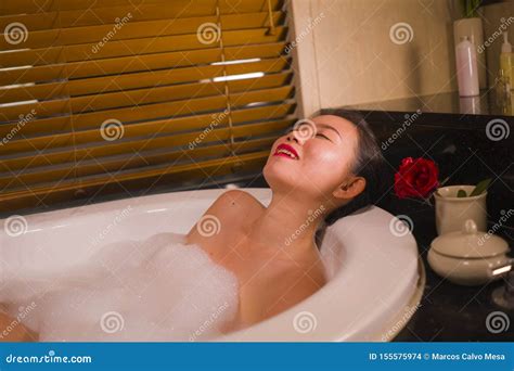 Young Beautiful Happy And Cheerful Asian Korean Woman Bathing At Home