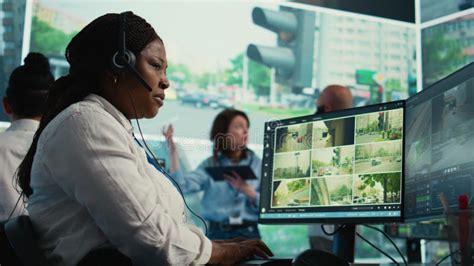 African American Employee Gathers Data On Cars In Traffic Through Red