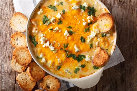Homemade Hot Buffalo Chicken Dip With Crostini Close Up In Baking Dish