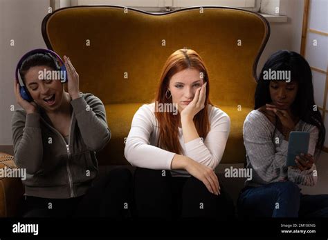 Social Isolation Due To Technology Addiction Girl Who Feels Lonely Among Her Friends Concept
