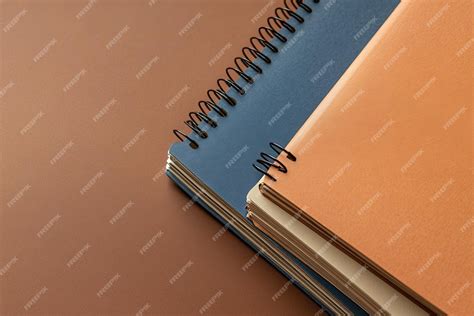 Three Spiral Notebooks On Brown Backdrop Premium Ai Generated Image