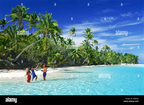 Tourists With Opened Coconuts On One Foot Island In Aitutaki Lagoon In