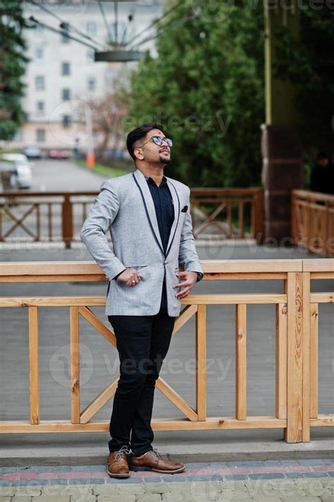 Stylish Indian Man With Bindi On Forehead And Glasses Wear On Gray
