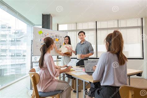 Ux Developer And Ui Designer Presenting And Testing Mobile App