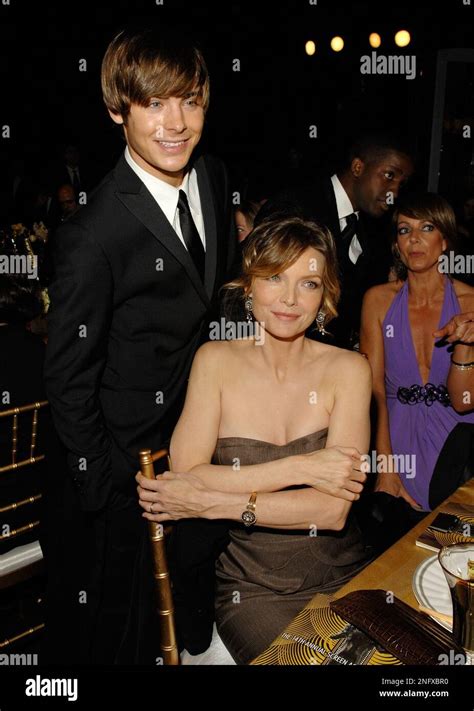 Zac Efron Left And Michelle Pfeiffer Pose At Their Table During The
