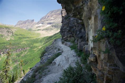 Narrow Trail On A Slope Of A Cliff With A Blue Sky In The Background