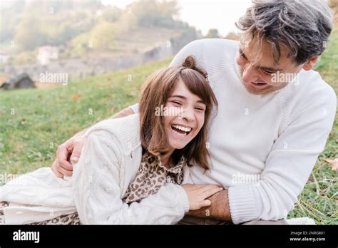 Italian Man With Gray Hair And Teenage Daughter On The Grass Stock