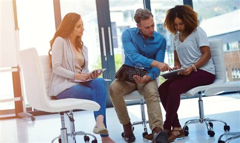 Taking The Collaborative Approach To Complete Their Assignment A Creative Team Using A Digital