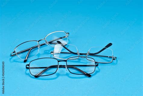 Different Types Of Glasses On A Blue Background Close Up Glasses With Rectangular And Round