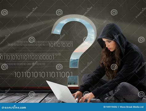 Woman Hacker Seated And Working On A Laptop With A Grey Background With A Question Mark Stock