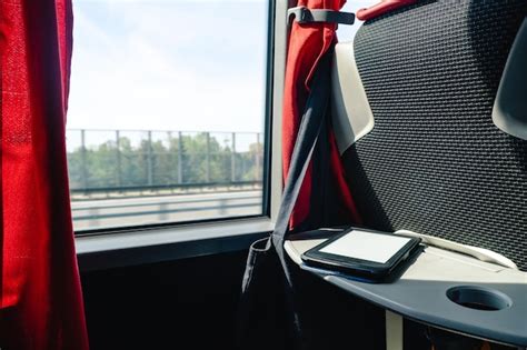 Premium Photo Road Trip Travel Concept Electric Book On The Table In The Bus