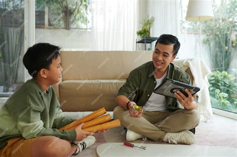 Premium Photo Teaching Son Assembling Table