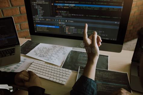 Two Software Developers Are Analyzing Together About The Code Written
