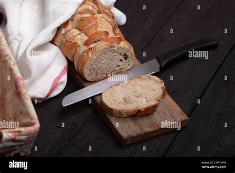 Rustic Bread Display With Sliced Whole Grain Loaf In Wicker Basket On