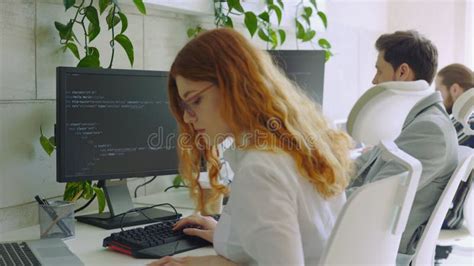 Enthusiastic Female Caucasian It Programmer Working On Desktop Computer
