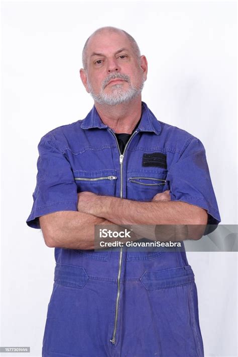 파란 작업복을 입은 하얀 수염 난 남자가 하얀 배경에 고립된 망치 도구를 들고 있다 50 54세에 대한 스톡 사진 및 기타 이미지 50 54세 50 59세 건설 산업