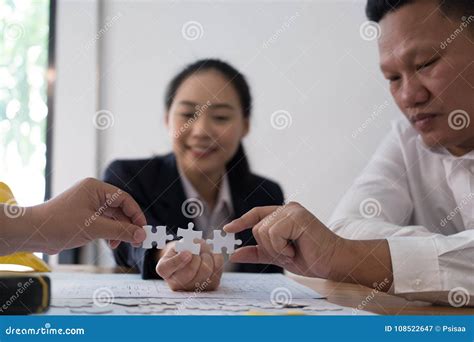 Business People Assembling Piece Of Puzzle Together Co Worker T Stock Image Image Of Office