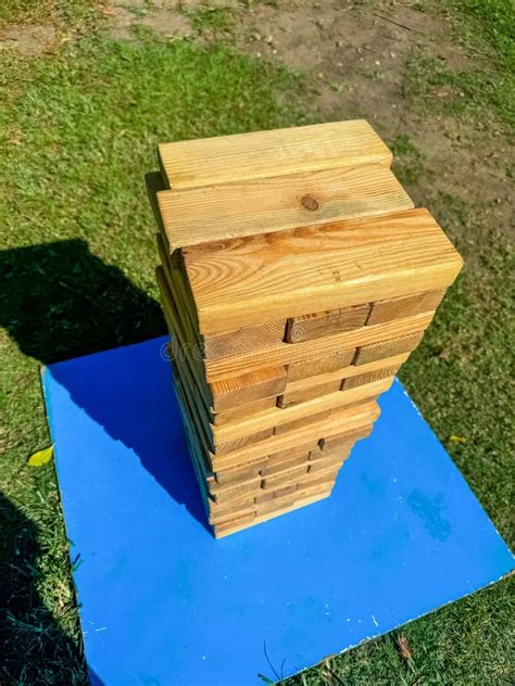 Outdoor Wooden Jenga Tower On A Blue Platform Ready For A Fun Garden