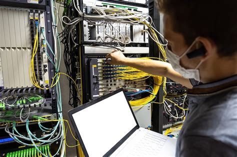 Premium Photo Technician Engineer Fixing Problem With Servers And Data In Cables Room