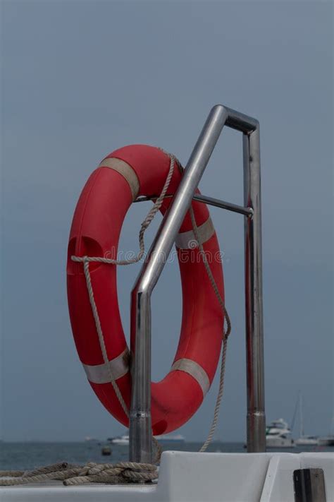 An Orange Safety Float Tied To The Railing Of A Yacht Stock Image