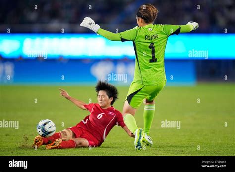 North Koreas Yujong Myong Takes A Shot Against Japans Goalkeeper