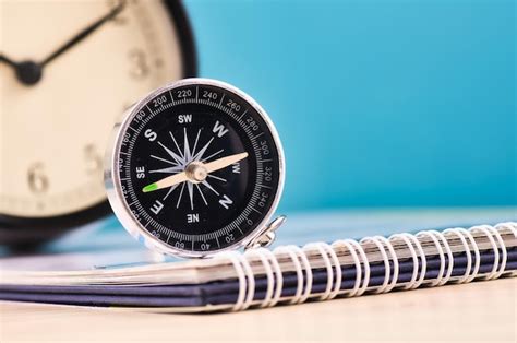 Premium Photo Close Up Of Compass And Book On Table