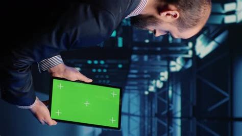 Vertical Video Database Admin Analyzing Greenscreen Display On Tablet