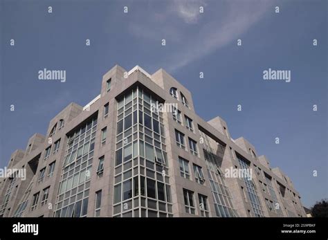 Modern Building With Large Glass Windows And Angular Shapes Under A Blue Sky Berlin Germany