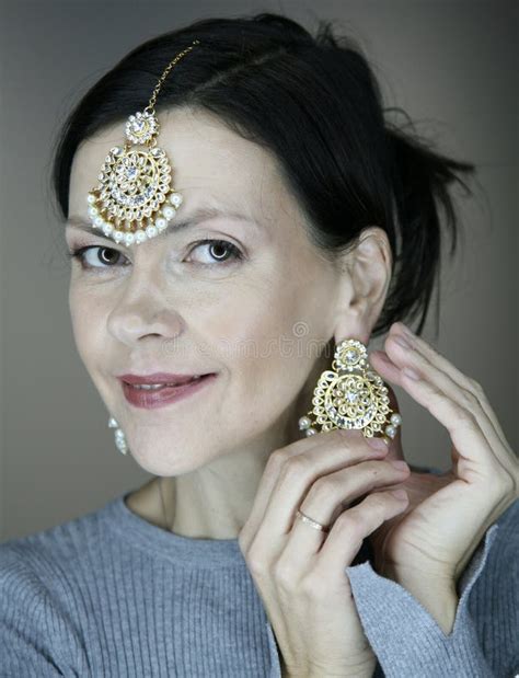 Attractive Smiling 51 Year Old Woman Wearing Indian Jewellery Posing