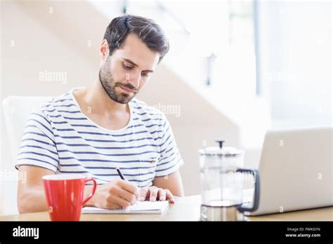 Man Writing Note On Notepad Stock Photo Alamy