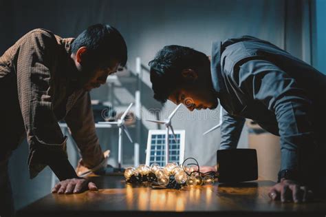 Two Engineers Testing Efficiency Of Solar Cell Panels Type With Led