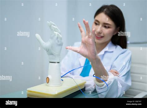 technician testing robotic bionic arm at prosthetic manufacturing stock