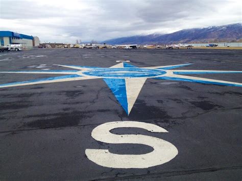 Premium Photo Painted Compass On Airport Runway Against Cloudy Sky