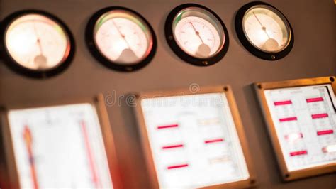 A Closeup View Of A Machine Dashboard With Illuminated Indicators And Graphs Showcasing The