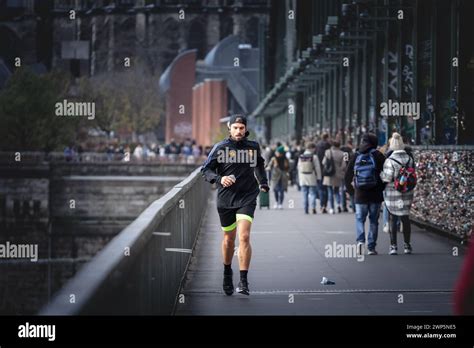Picture Of A German Runner Running On The Hohenzollern Bridge In