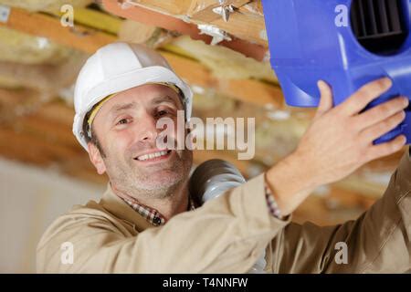Man Installing Thermal Roof Insulation Layer Using Mineral Wool Panels Attic Renovation And
