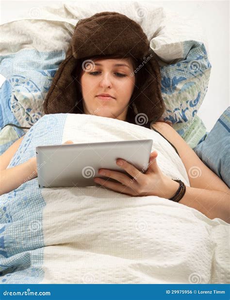 Das Mädchen Ist Liegenkranker Im Bett Und Im Schauen in Ihre Tablette Stockfoto - Bild von ...