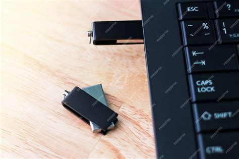 Premium Photo Handy Drive Or Usb Flash Memory Connected To The Computer Placed On The Desk