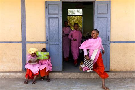 Three Women In Bright Pink Dresses Are Standing Outside The Door Of A