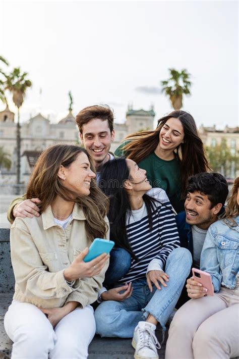 Young Group Of Happy Friends Laughing While Using Mobile Phones At City Street Stock Image