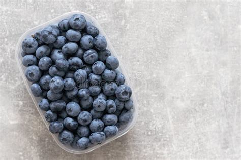 Freshly Blueberry In A Plastic Box Packed On A White Background Space For Text Stock Image