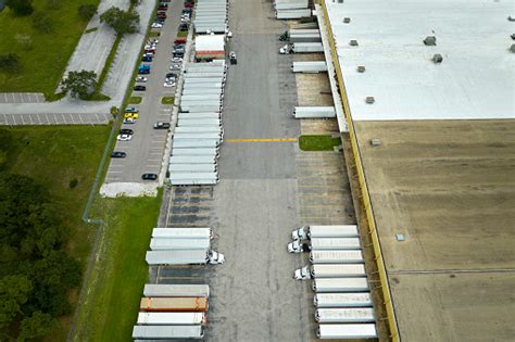 Aerial View Of Large Commercial Distribution Center With Many Trucks