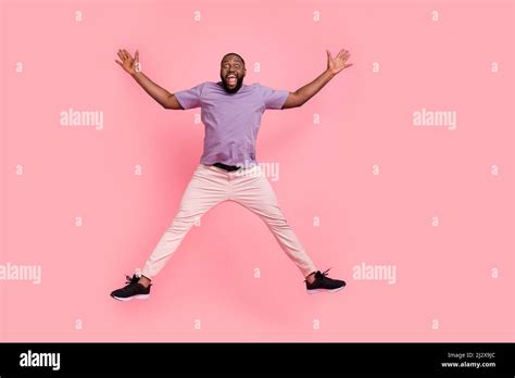 Full Length Body Size View Of Attractive Cheerful Guy Jumping Fooling
