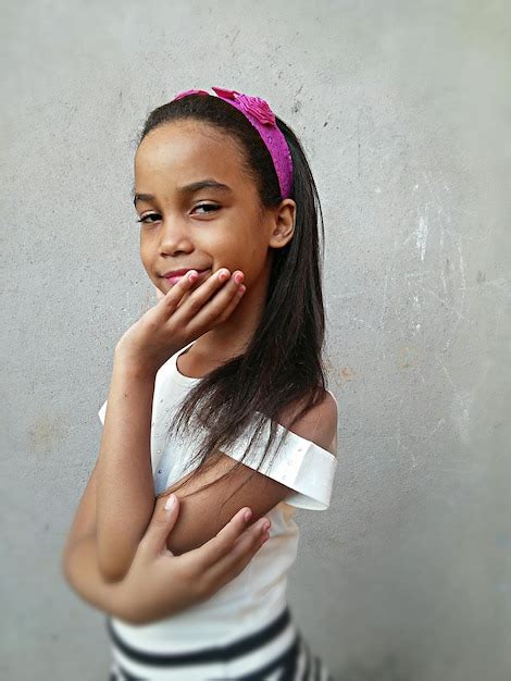 Premium Photo Portrait Of Girl Standing Against Wall